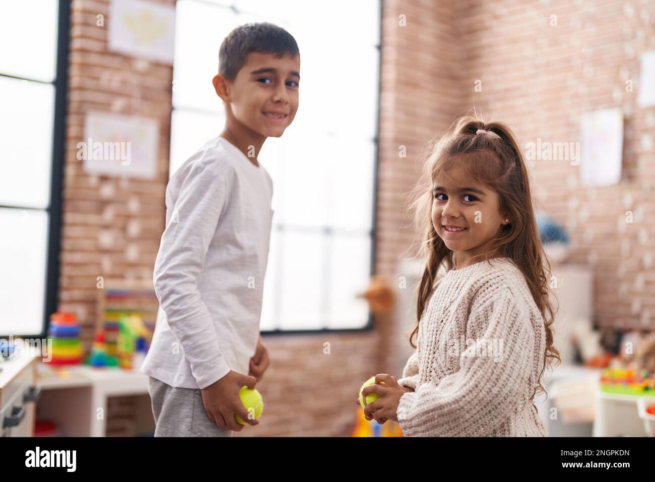 Brother and sister smiling confident playing bowling at kindergarten ...
