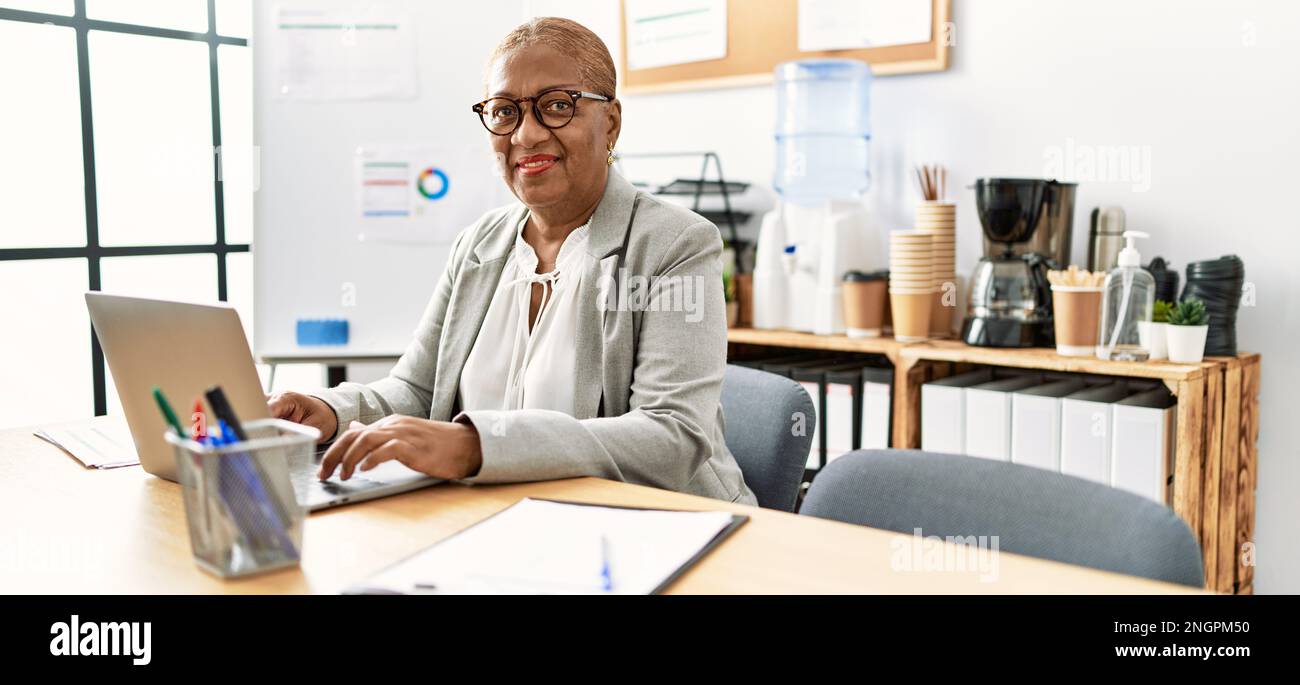 Senior african american woman business worker using laptop working at ...