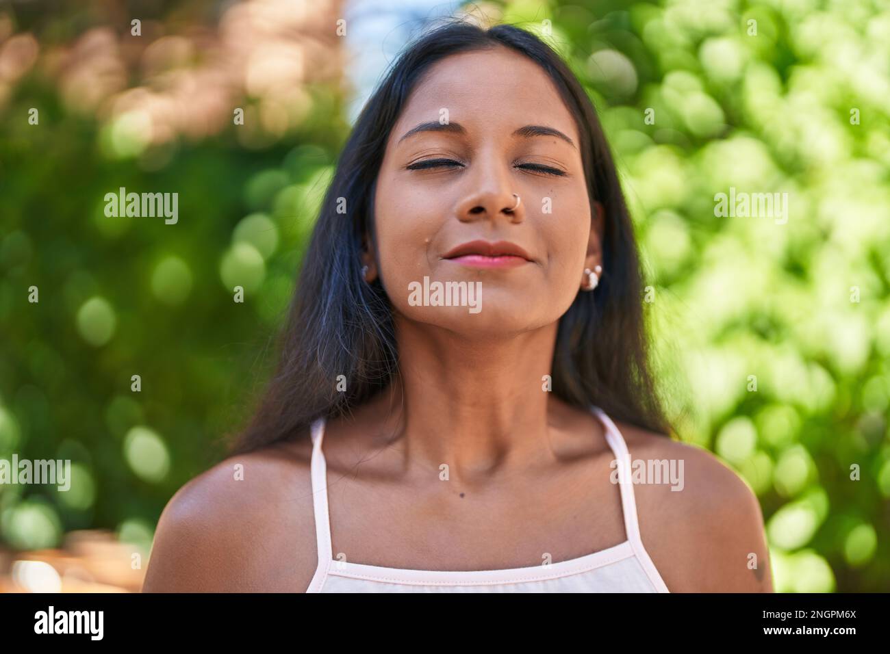 Young beautiful woman breathing with closed eyes at park Stock Photo ...