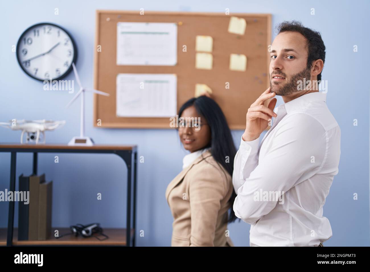 Man and woman business workers looking clock at office Stock Photo - Alamy