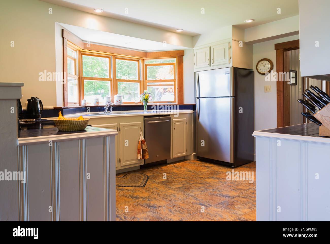 Kitchen with white painted pinewood cabinets, blue ceramic countertops ...