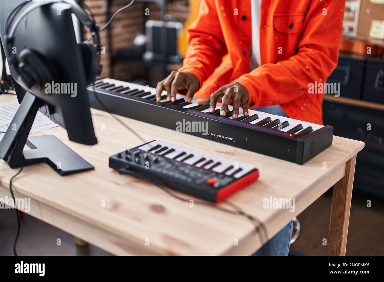 African american man musician playing piano keyboard at music studio ...