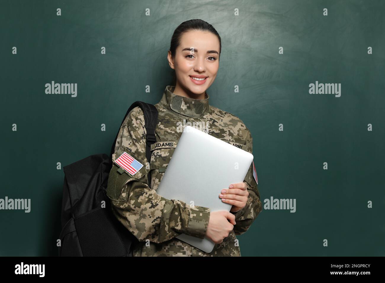 Female soldier with laptop and backpack near green chalkboard. Military ...