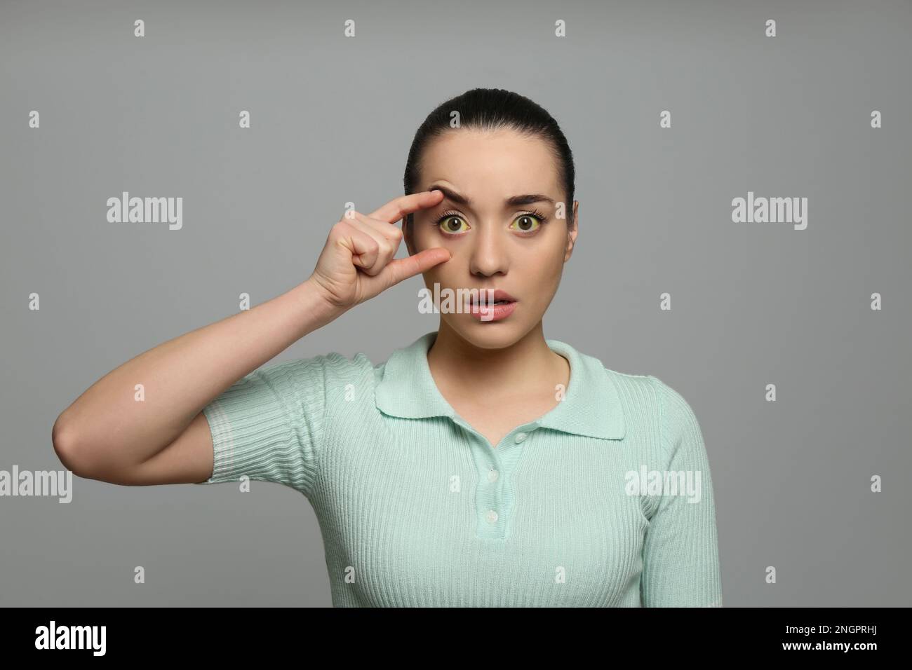 Woman Checking Her Health Condition On Grey Background Yellow Eyes As
