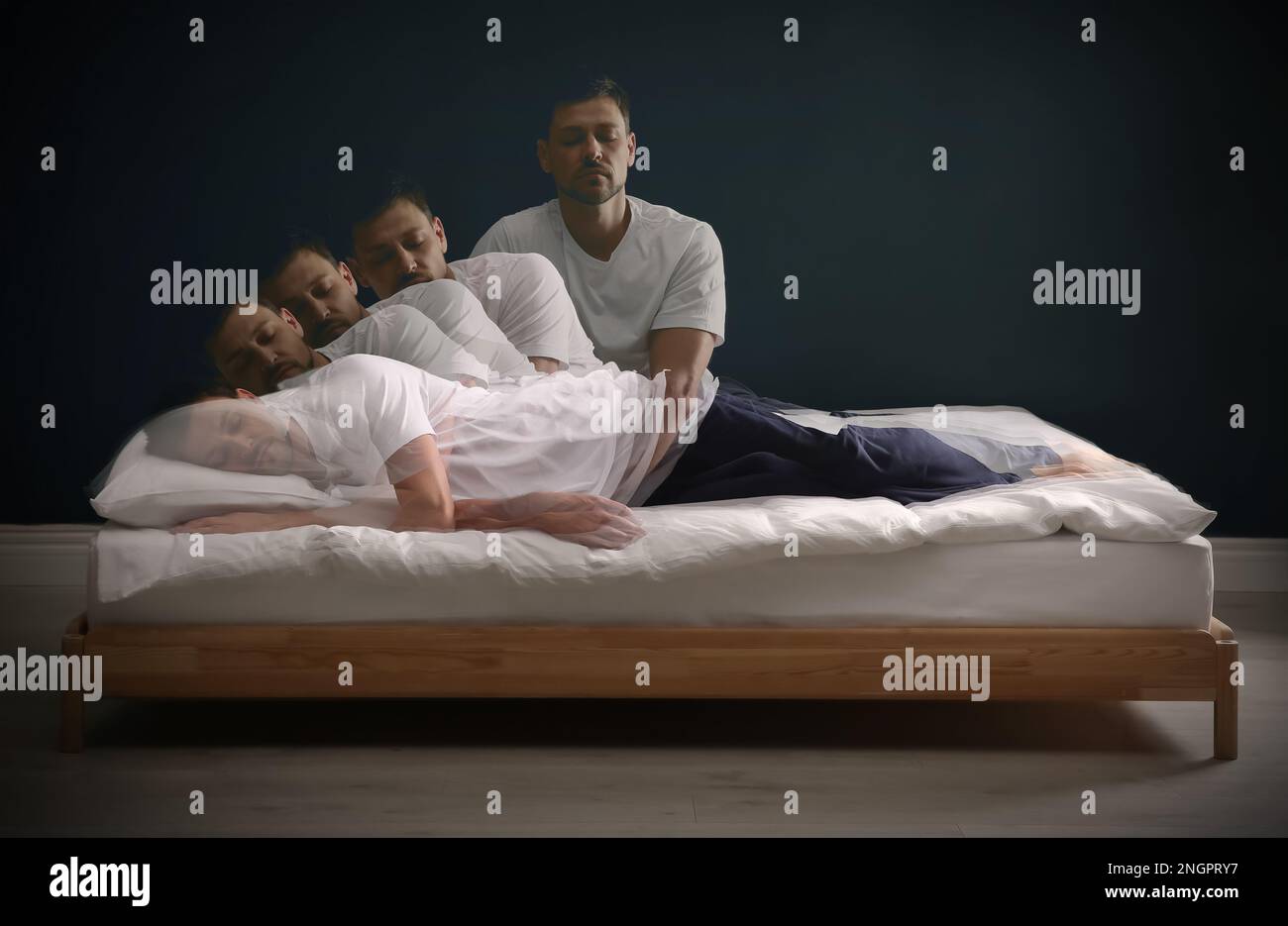 Somnambulist rising from bed near dark wall indoors, multiple exposure ...