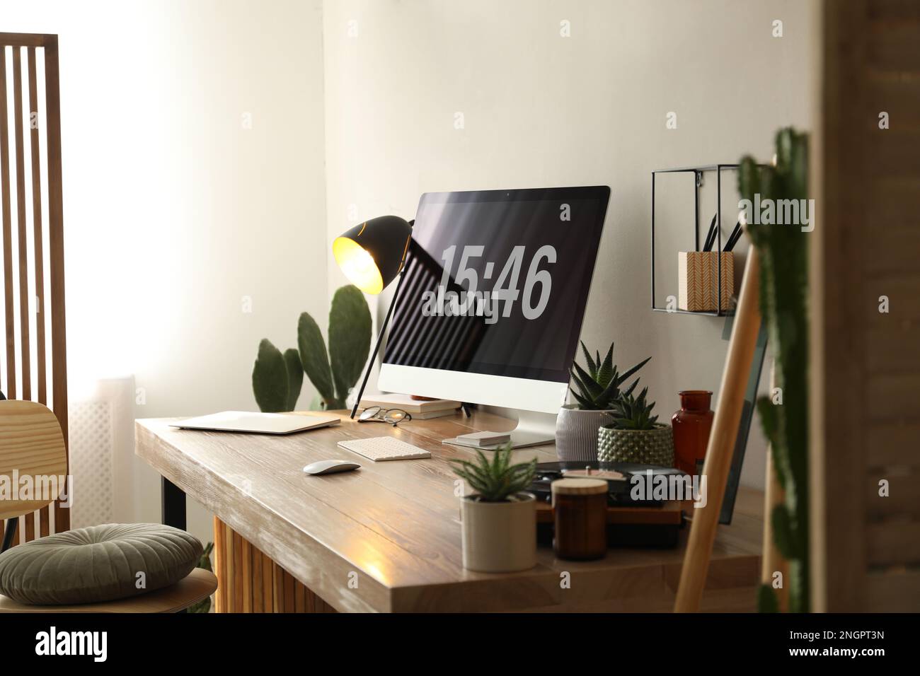 Modern computer and laptop on wooden desk in room. Interior design ...