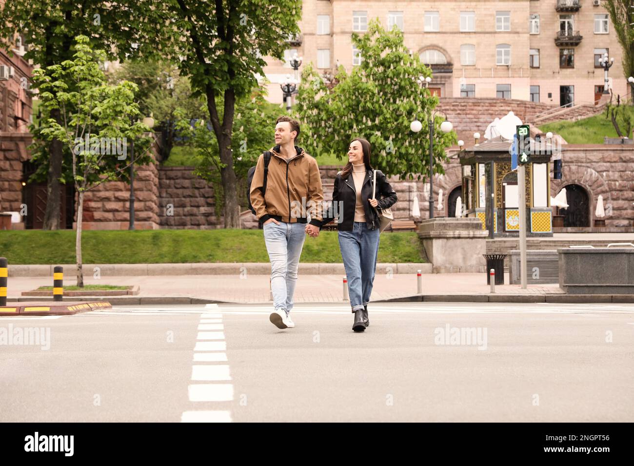 Young couple crossing street. Traffic rules and regulations Stock Photo ...