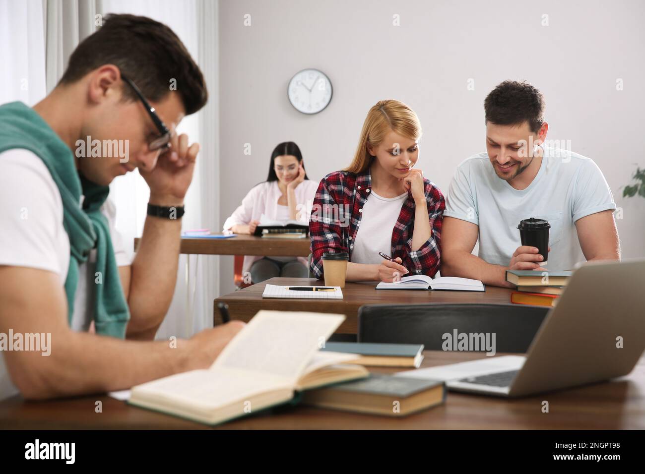 Students reading books and studying in library Stock Photo - Alamy