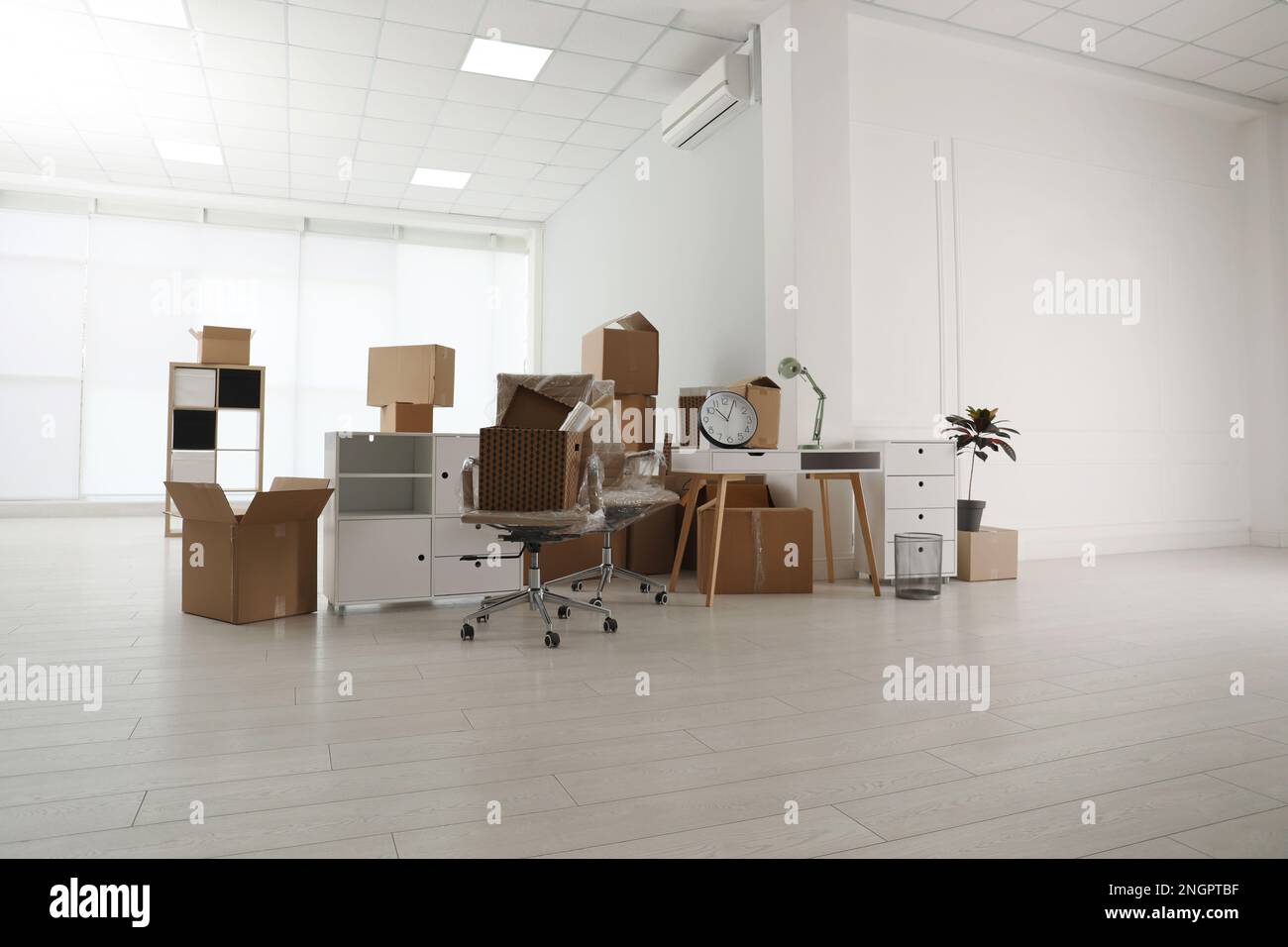 Cardboard boxes and packed stuff in office. Moving day Stock Photo - Alamy