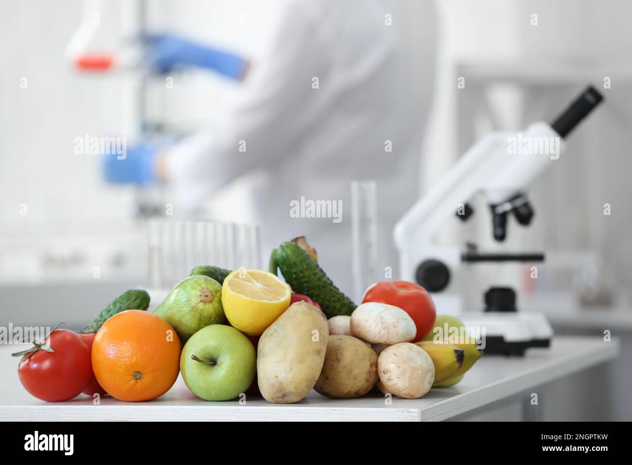 Fresh vegetables, fruits on table and scientist proceeding quality ...