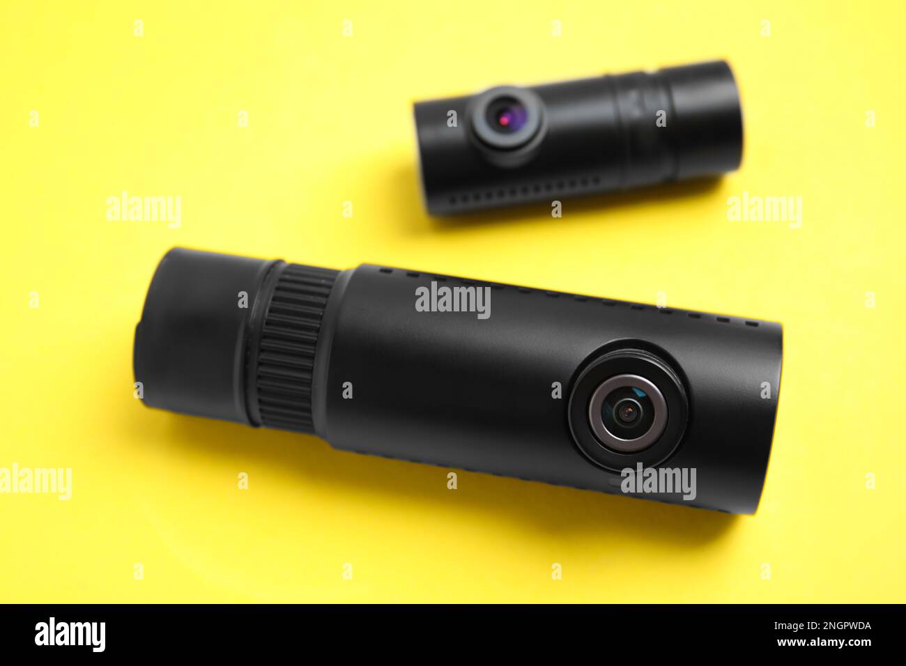 Black modern car cameras on yellow background, closeup Stock Photo - Alamy