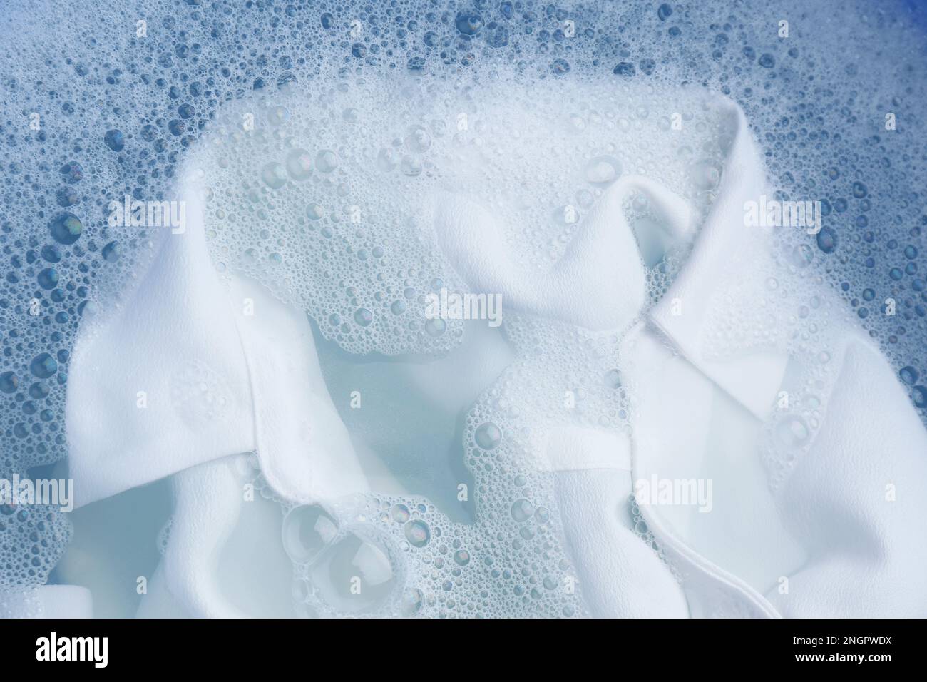 White clothing in suds, top view. Hand washing laundry Stock Photo - Alamy