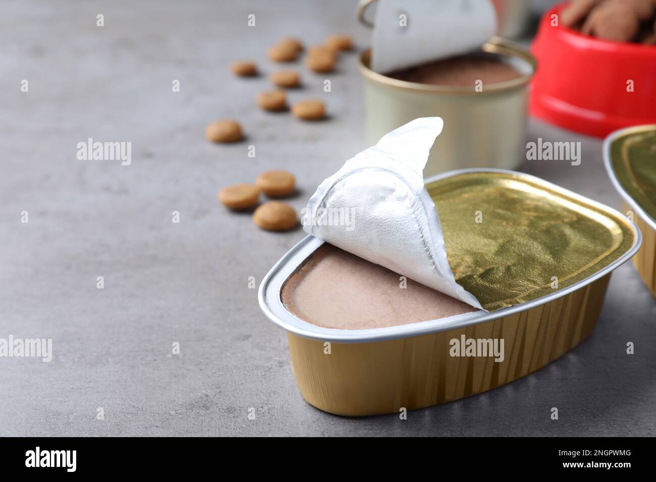 Open package of wet pet food on grey table. Space for text Stock Photo ...