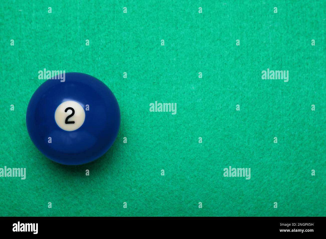 Billiard ball with number 2 on green table, top view. Space for text ...
