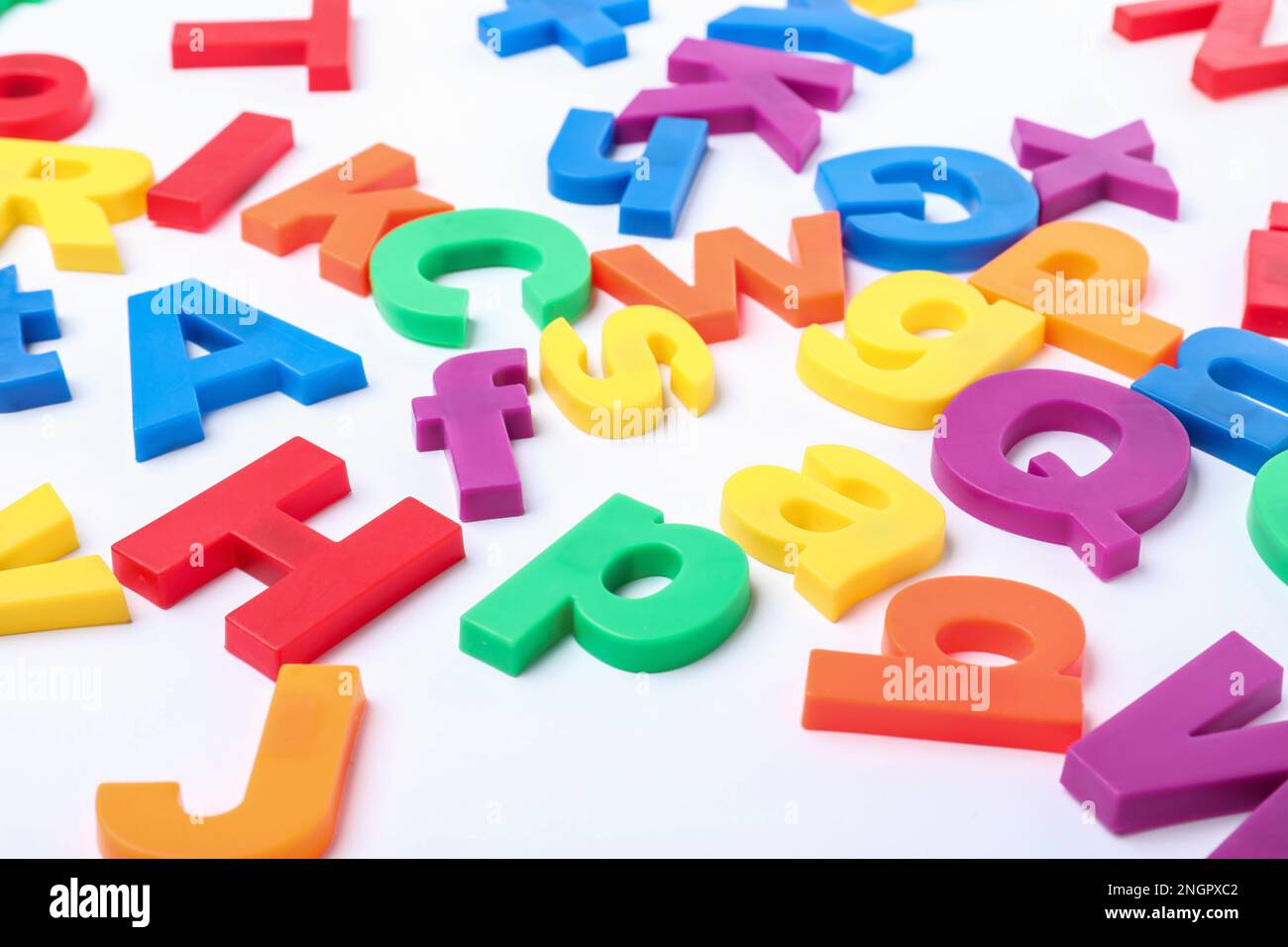 Many colorful magnetic letters on white background Stock Photo - Alamy