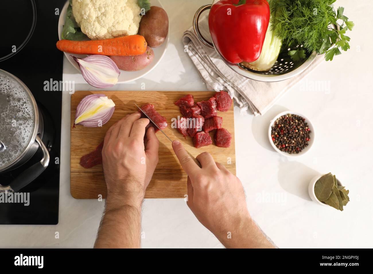 Man cutting meat to make bouillon at countertop, top view. Homemade ...