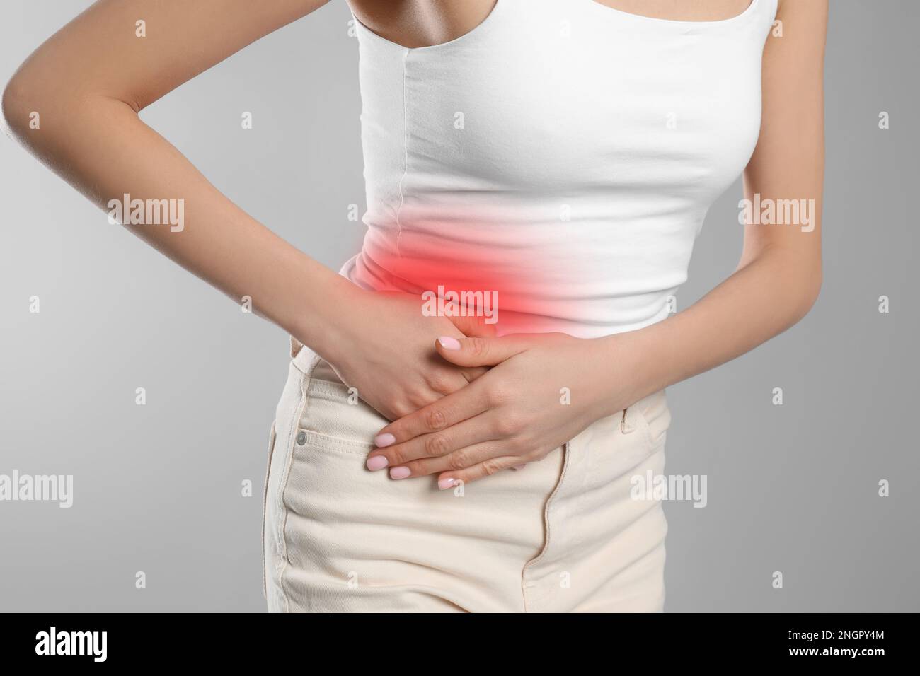 Woman suffering from appendicitis inflammation on grey background ...