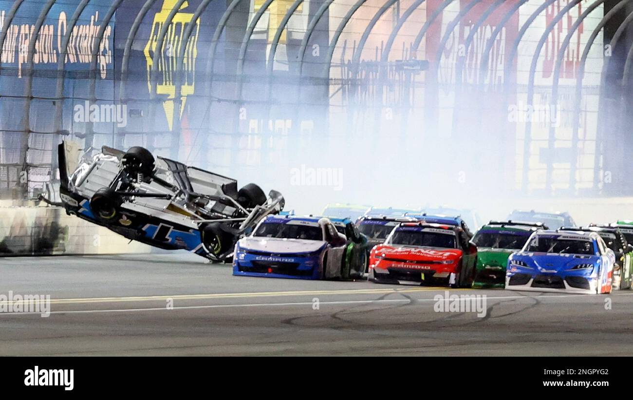 Sam Mayer, left, goes upside down as he crashes on the back stretch as ...