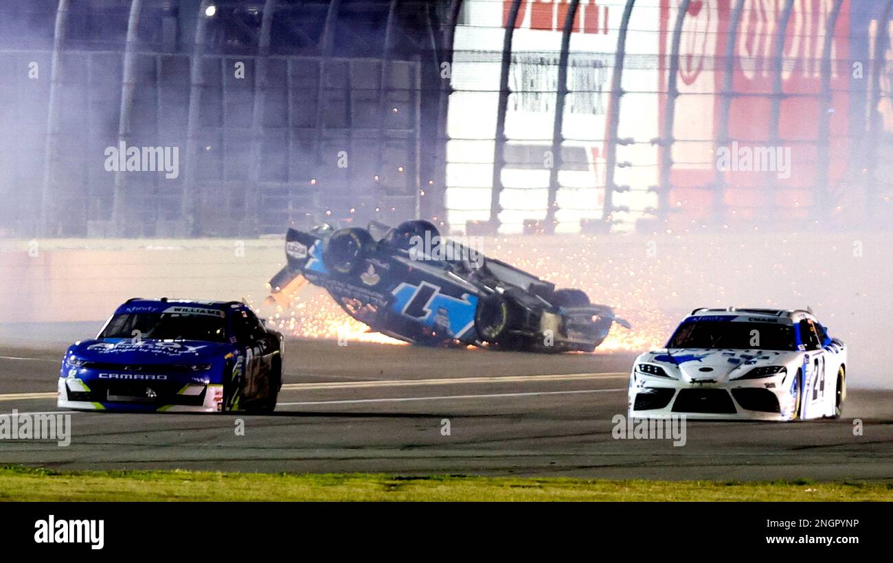 Sam Mayer, left, goes upside down as he crashes on the back stretch as ...