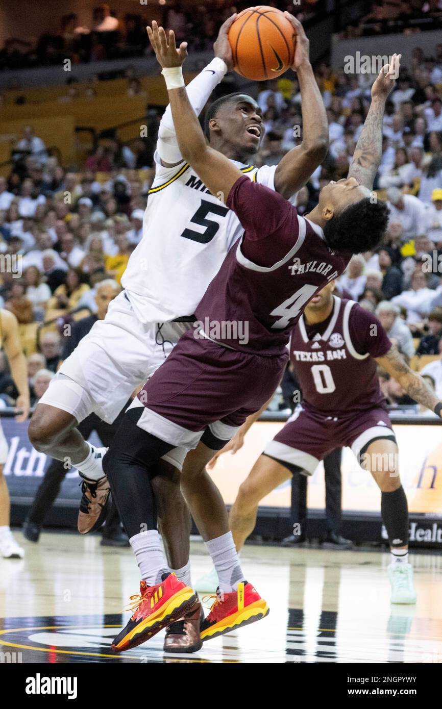 Missouri's D'Moi Hodge, top, shoots over Texas A&M's Wade Taylor IV ...