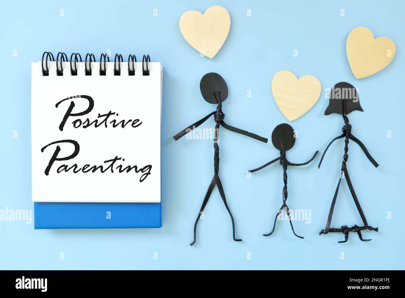 Positive parenting approach concept. Text written on blue notepad with ...