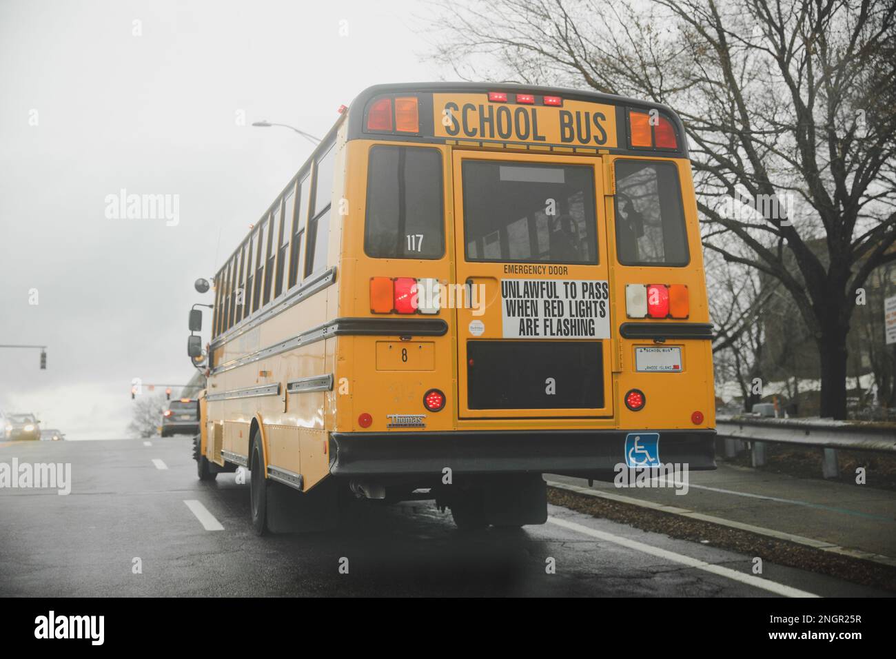 yellow school bus in public with stop sign showing Stock Photo - Alamy