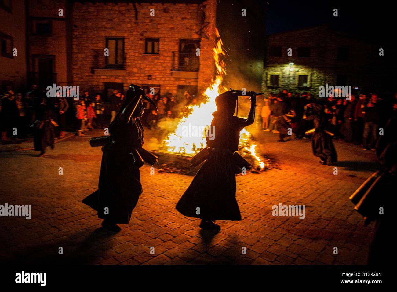 People dressed as "Devils of Luzon" run around the bonfire during the ...