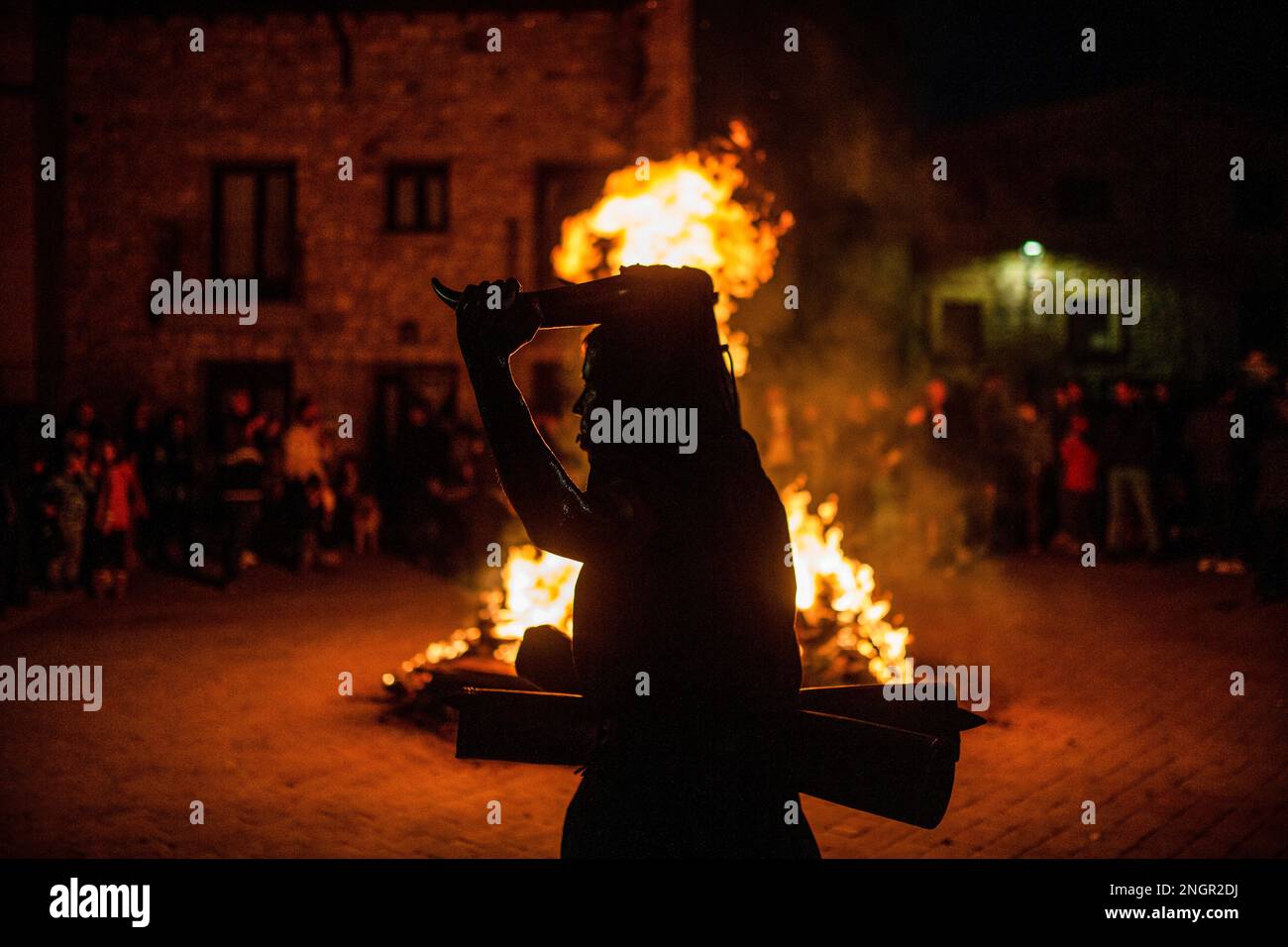 A participant dressed as "Diablos de Luzon" jumps in front of the ...