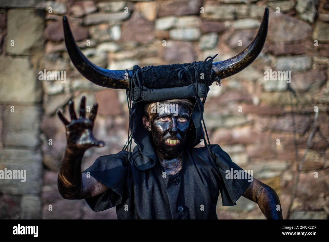 A woman disguised as "Devil of Luzon" poses for a photograph prior to ...
