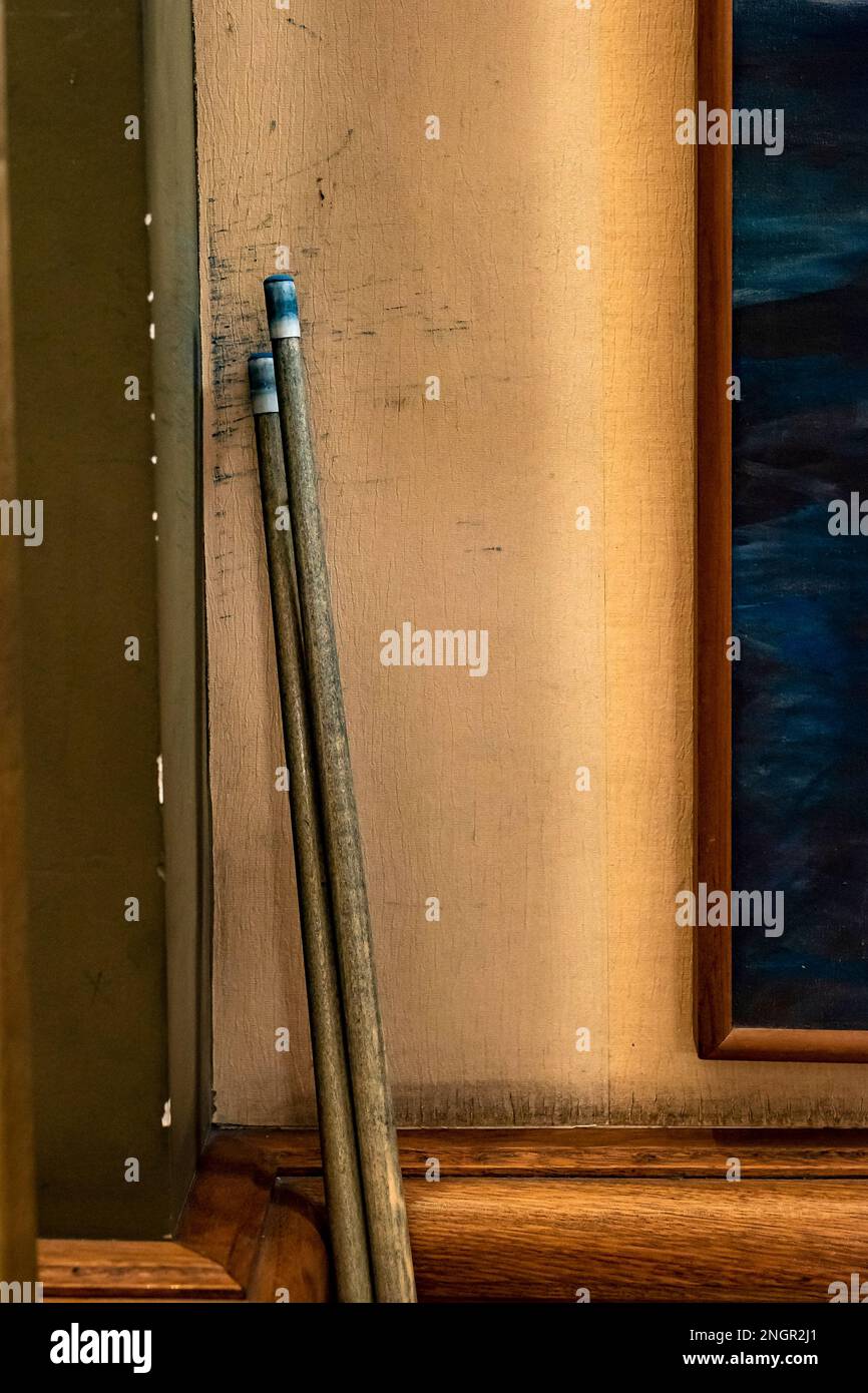Two billiard cue sticks on the wall Stock Photo - Alamy
