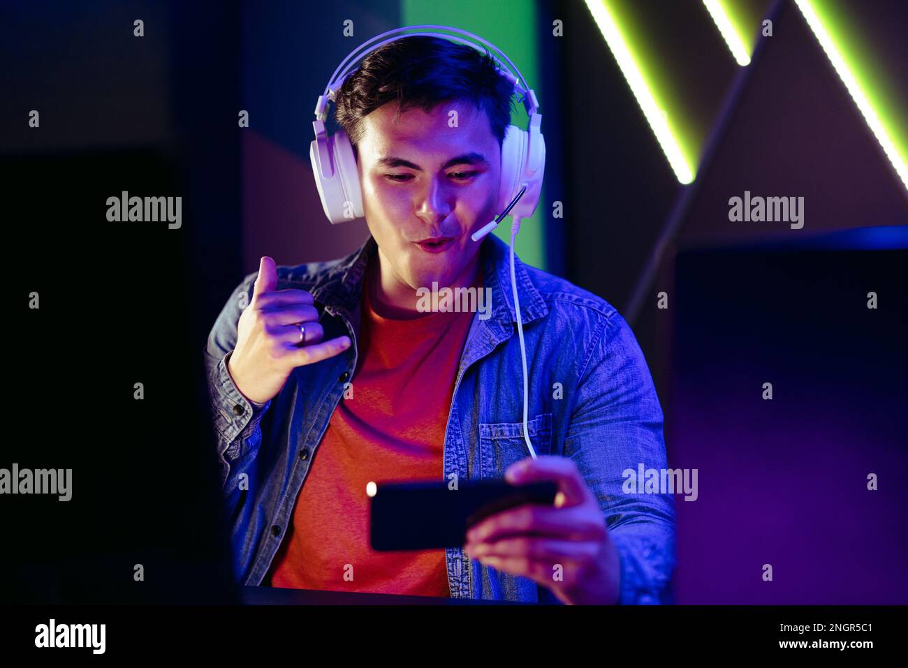 Young male gamer connecting with other video game players and streamers ...