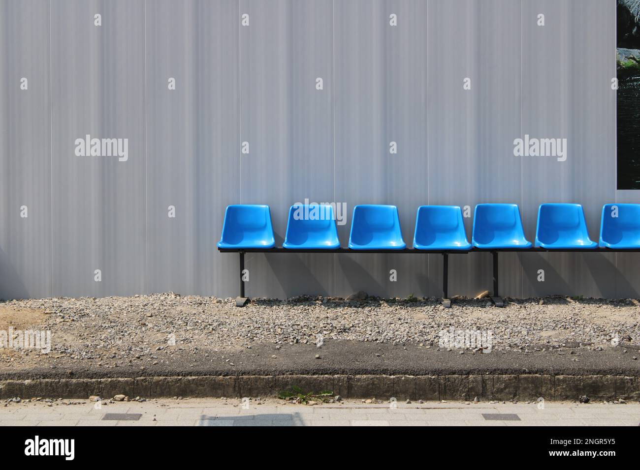 Blue bus stop seats Stock Photo - Alamy