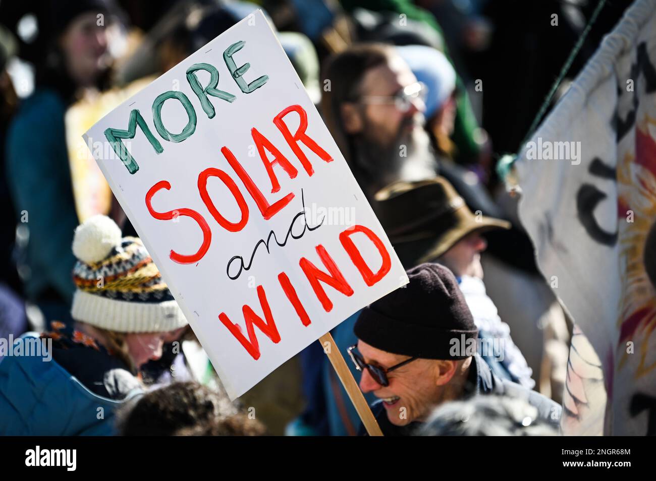 Signs call for more renewable power at a march calling for action to ...