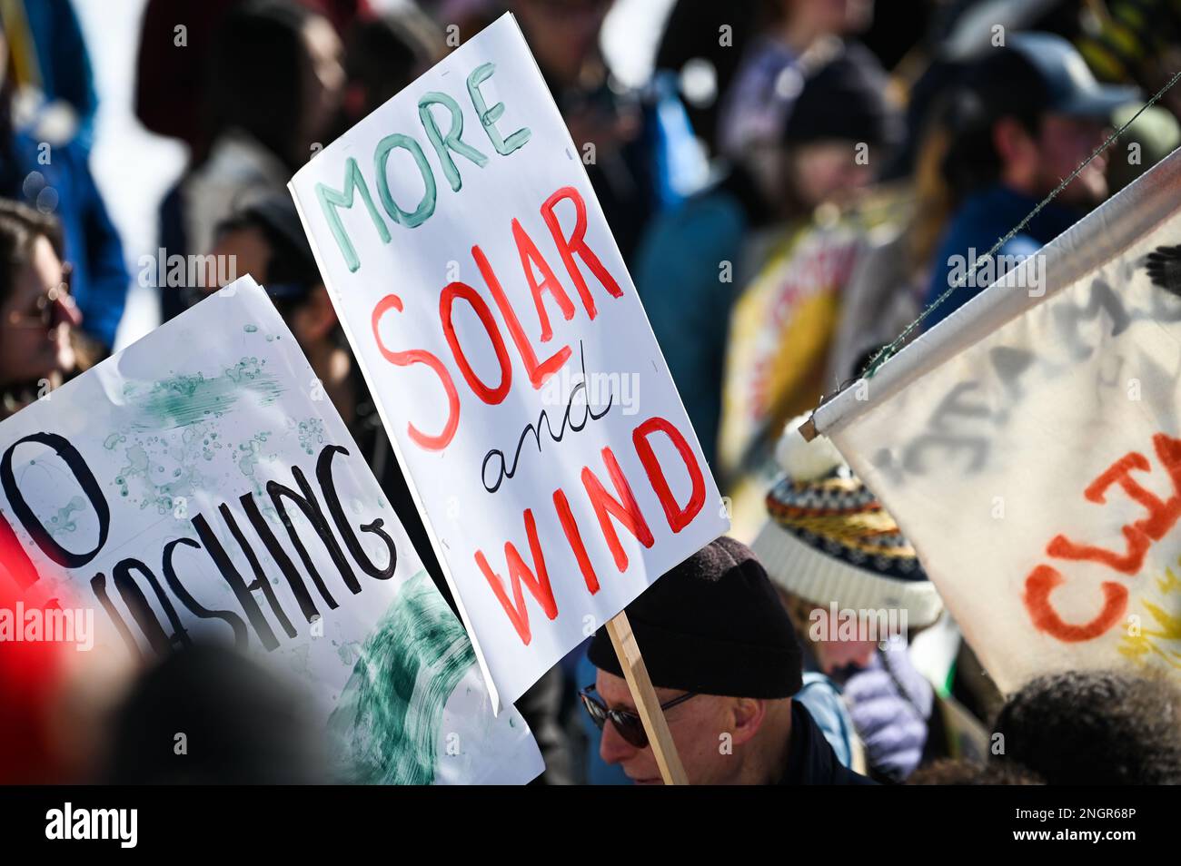 Signs call for more renewable power at a march calling for action to ...