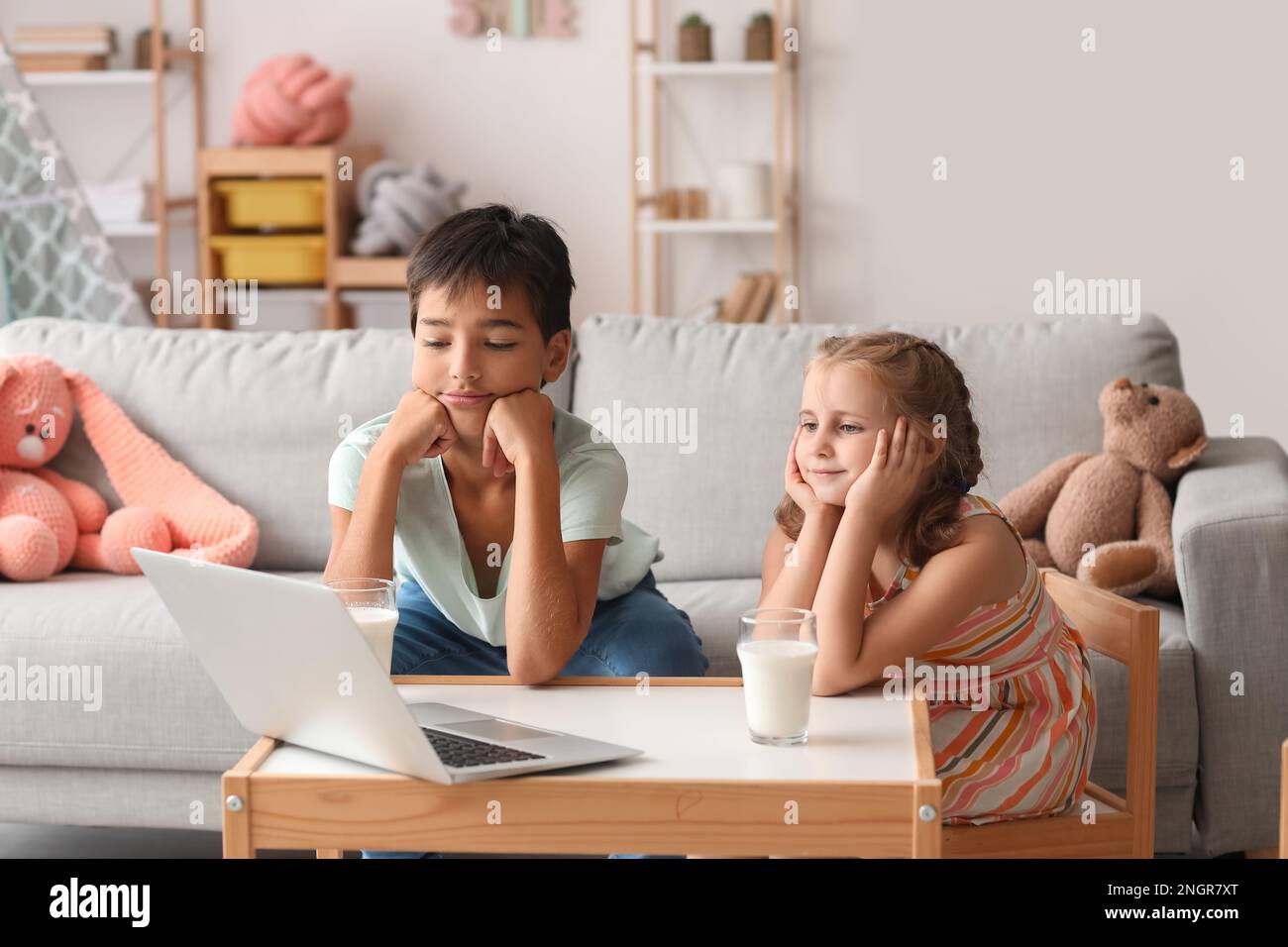 Little boy and girl watching cartoons on laptop at home Stock Photo - Alamy