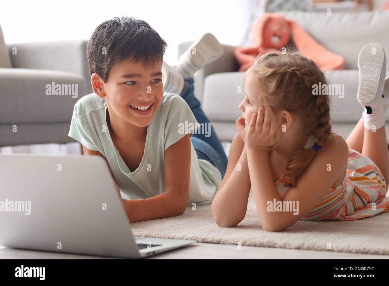 Little boy and girl watching cartoons on laptop at home Stock Photo - Alamy
