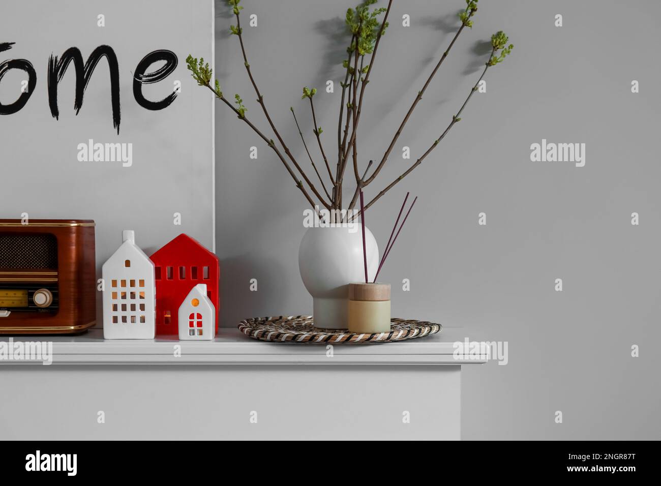 Vase with tree branches, house candle holders and retro radio receiver ...