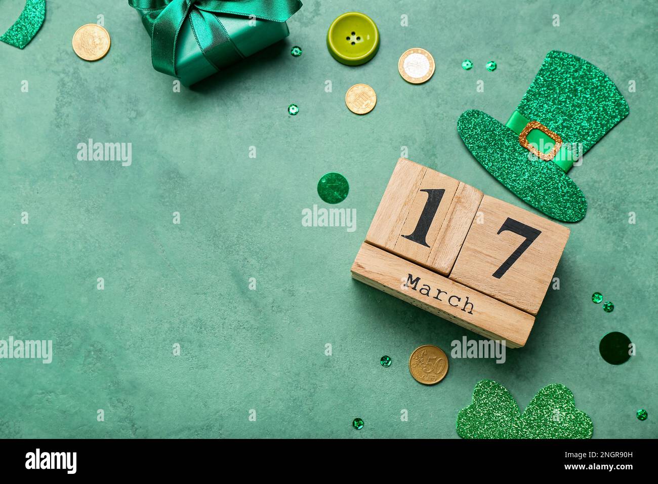 Calendar with date of St. Patrick's Day, paper Leprechaun hat and coins ...
