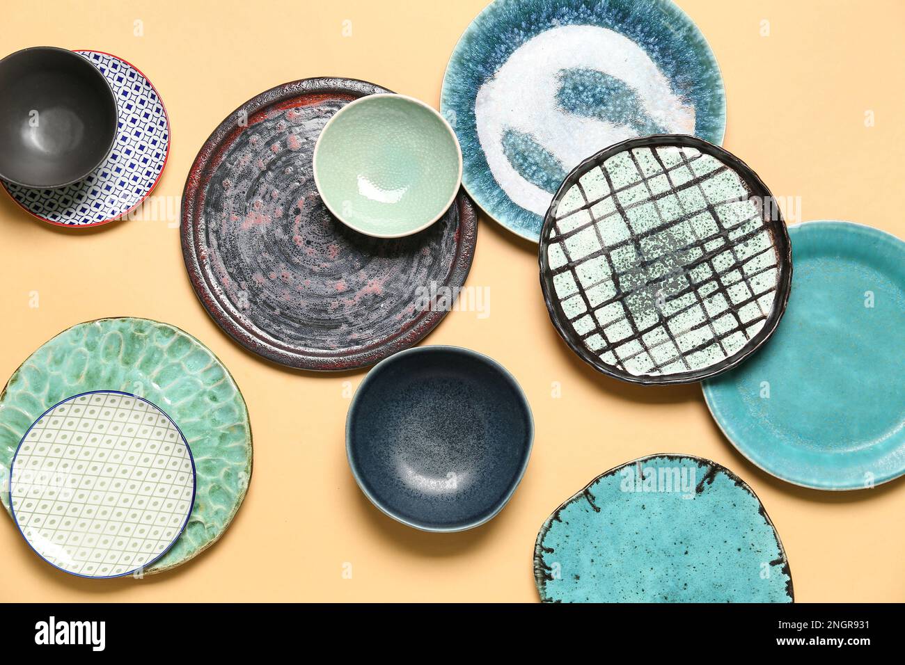 Set of different ceramic plates on color background Stock Photo - Alamy