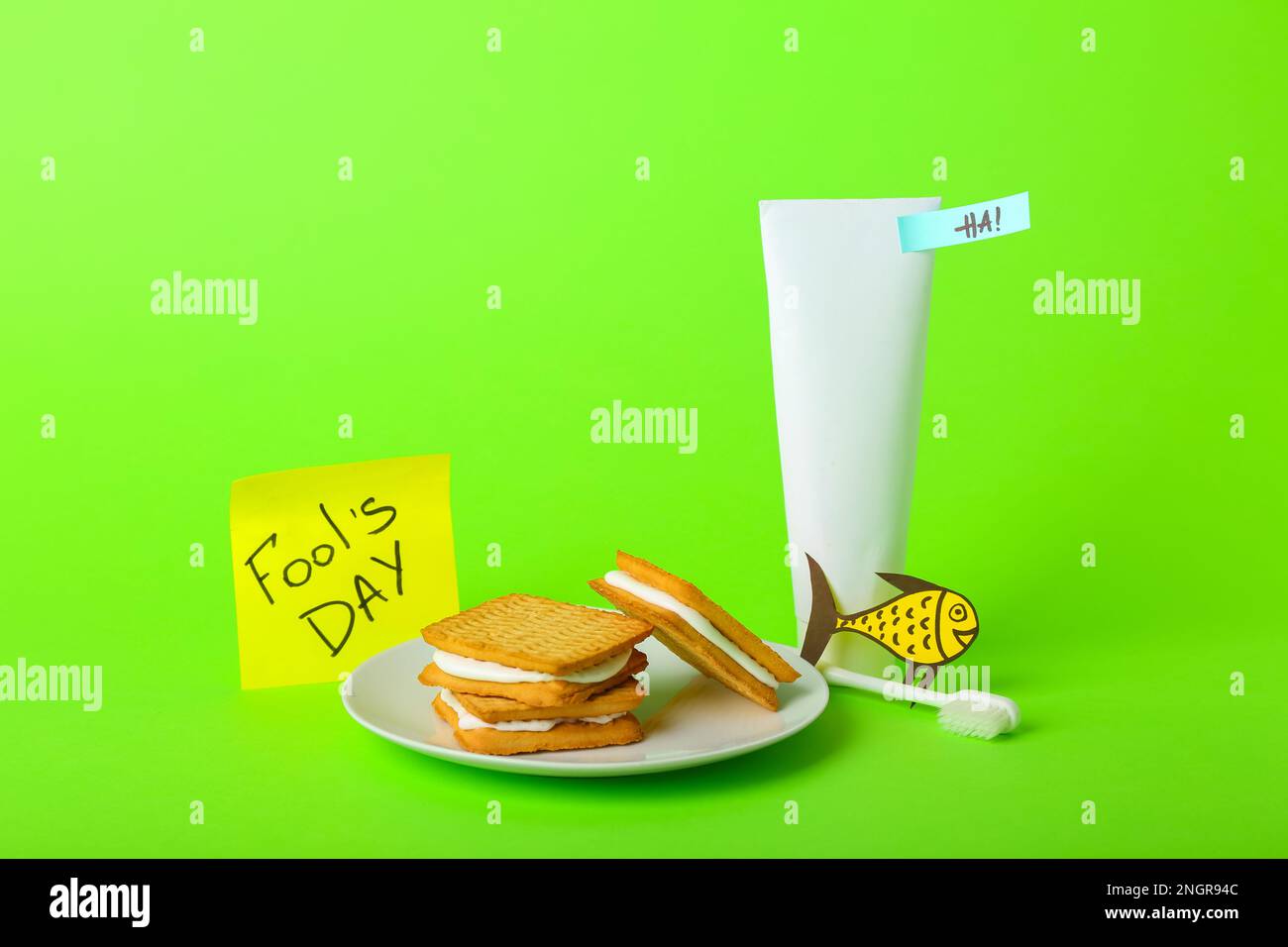 Plate of cookies, toothpaste, toothbrush and sticky note with text FOOL ...