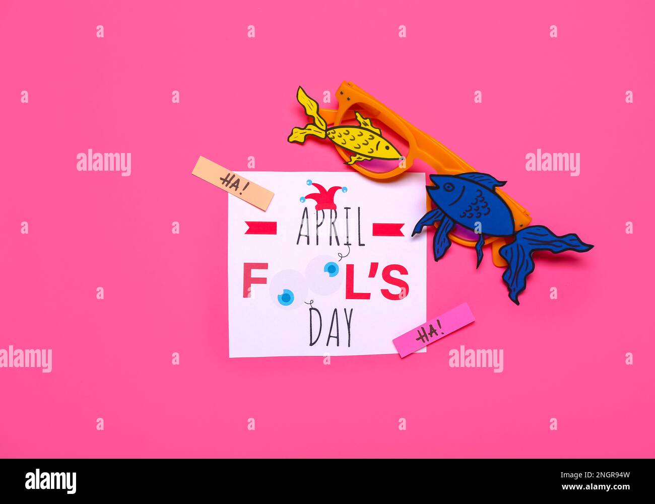 Card with text APRIL FOOL'S DAY, eyeglasses and paper fishes on pink ...