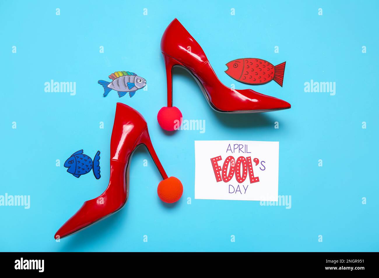 Stylish high-heeled shoes, clown noses, paper fishes and card with text ...