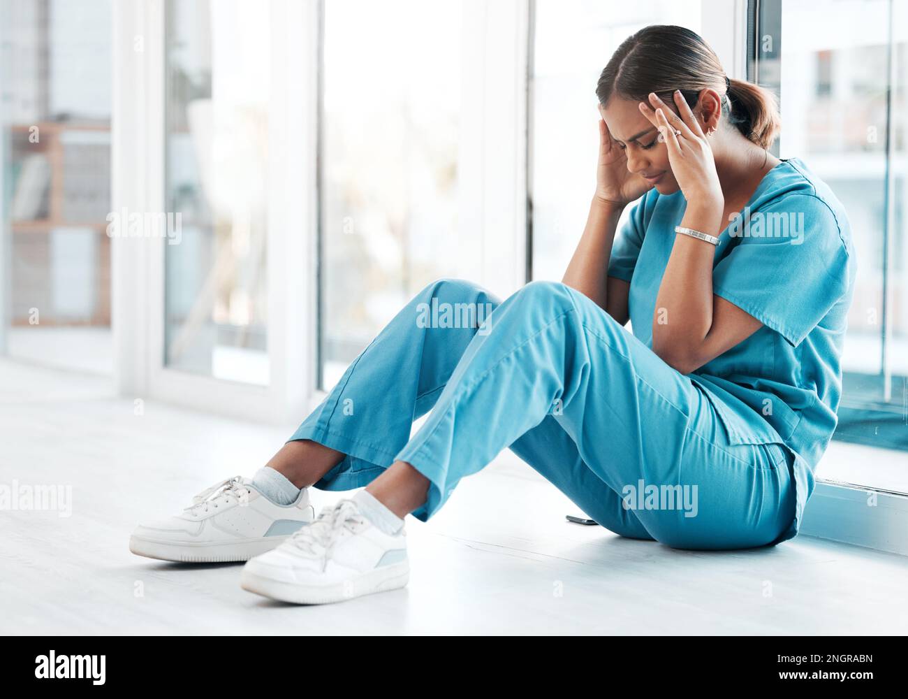 Depression, headache and medical with nurse on floor of hospital for ...