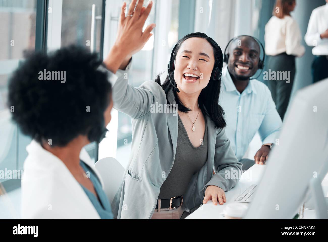Success, teamwork and high five with asian woman in call center for ...