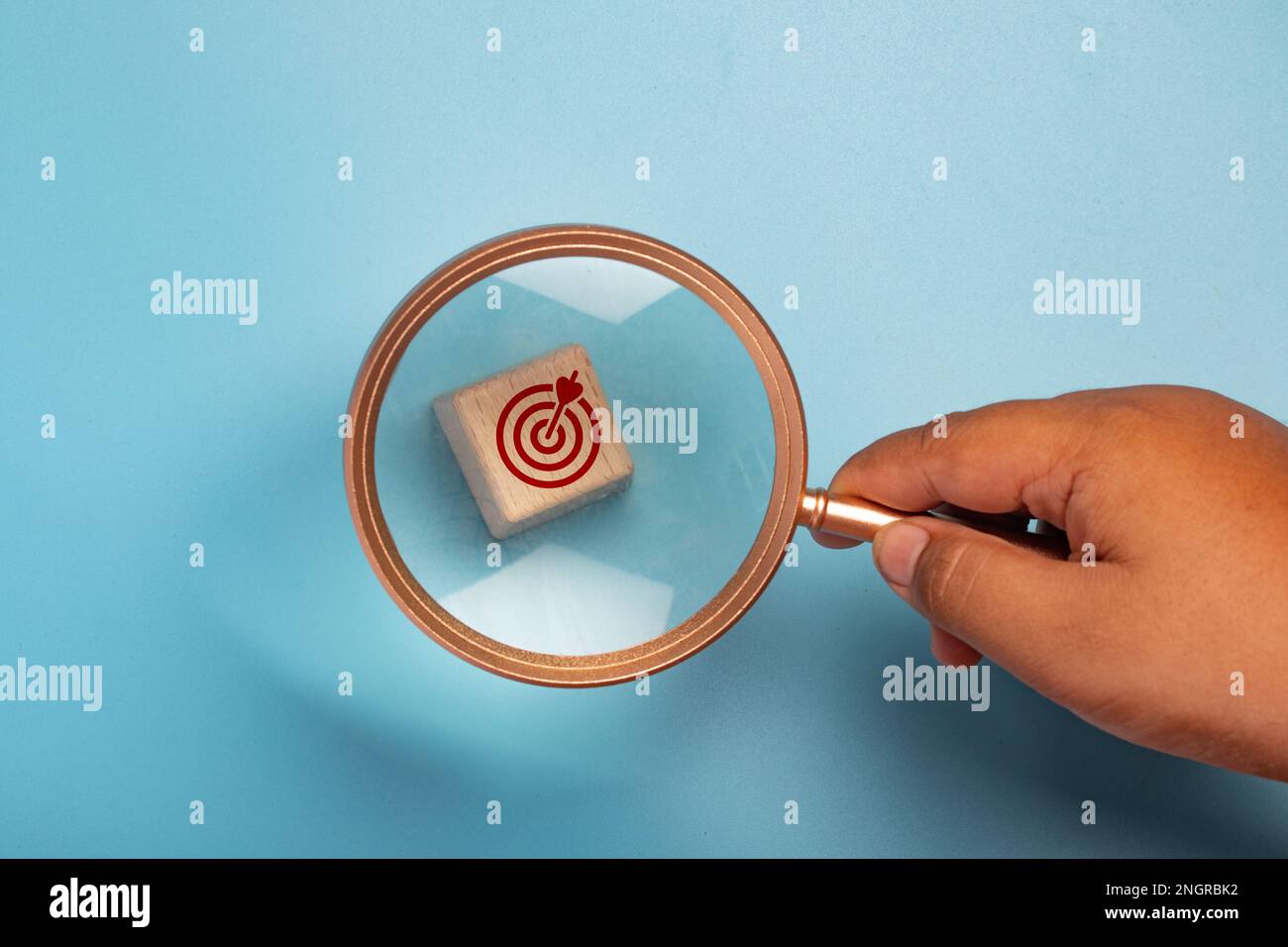 Magnifying glass with wooden block, target symbol.Work targeting ...