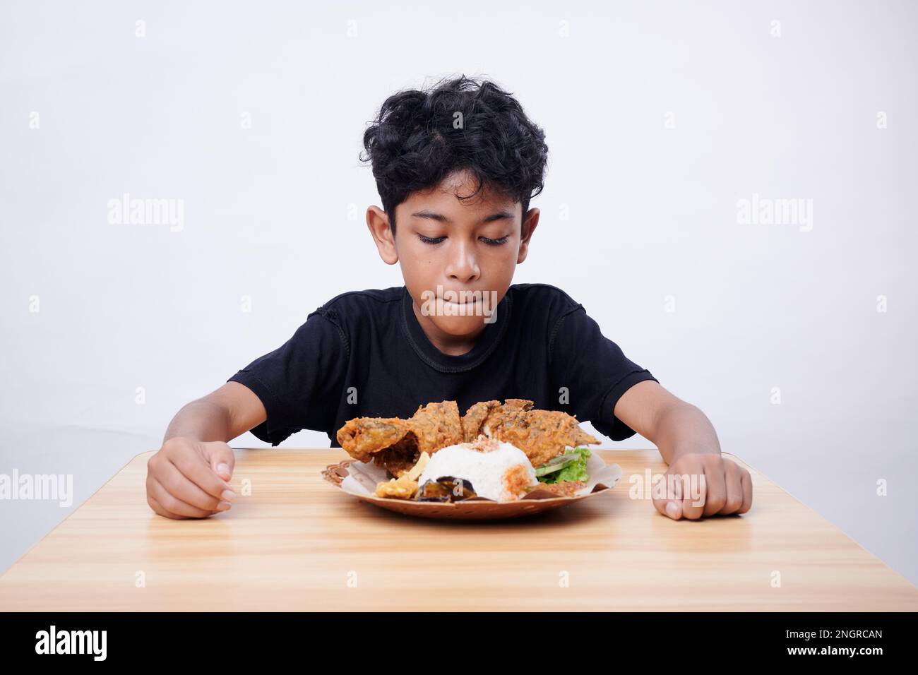 Boy eating Fried Fish and rice at lunch break at school Stock Photo - Alamy