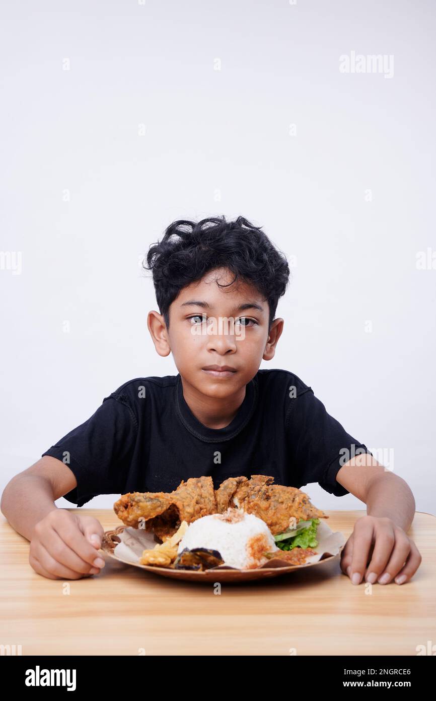Boy eating Fried Fish and rice at lunch break at school Stock Photo - Alamy