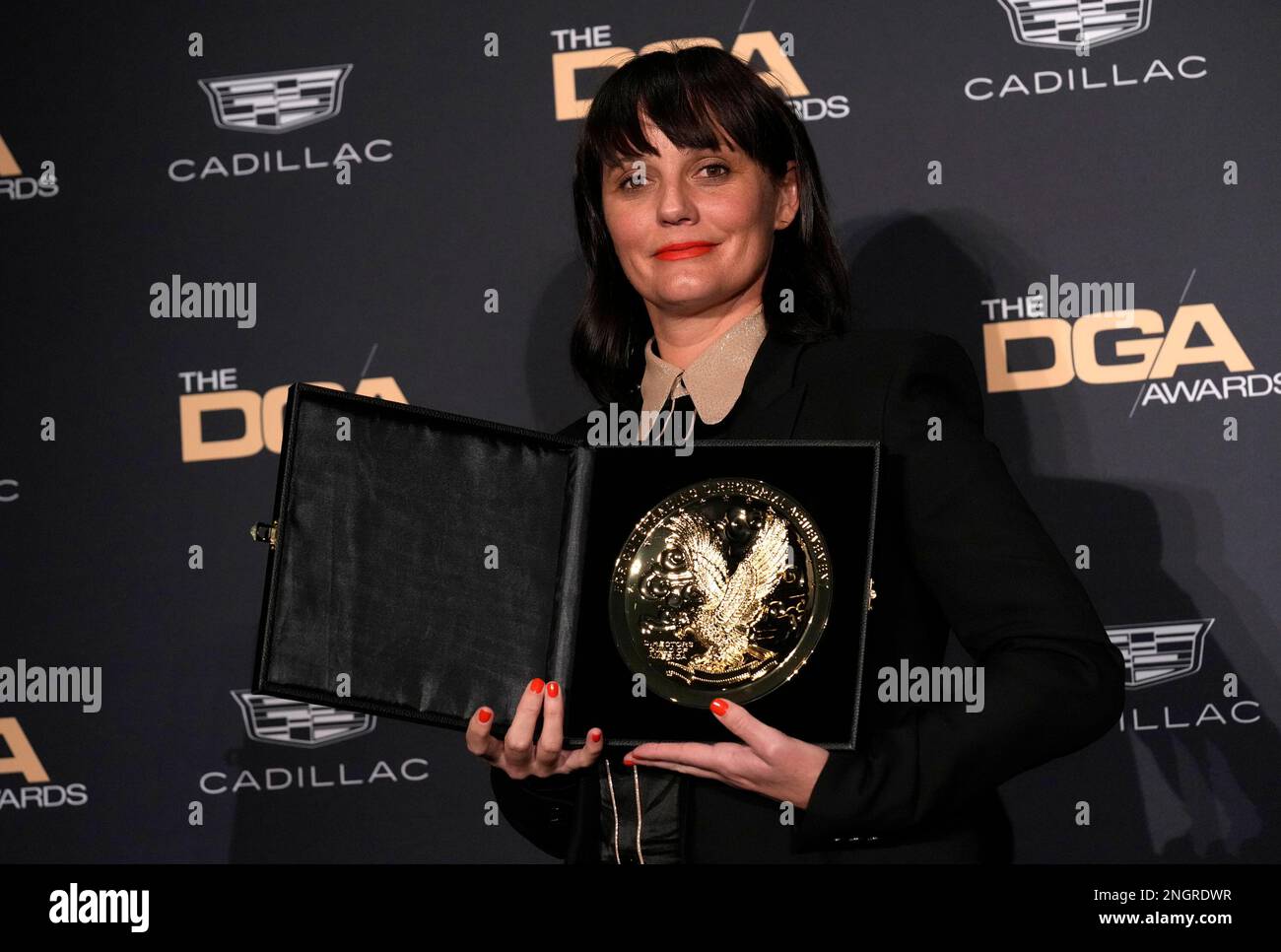 Kim Gehrig poses in the press room with the award for outstanding ...