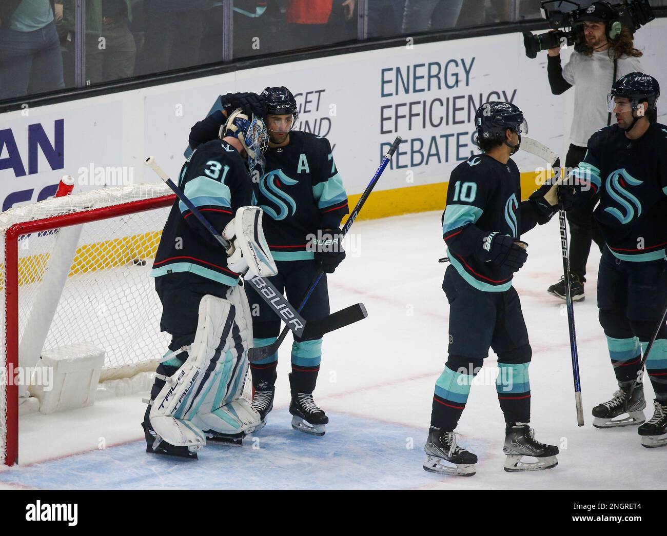 Seattle Kraken goaltender Philipp Grubauer (31) is greeted by right ...