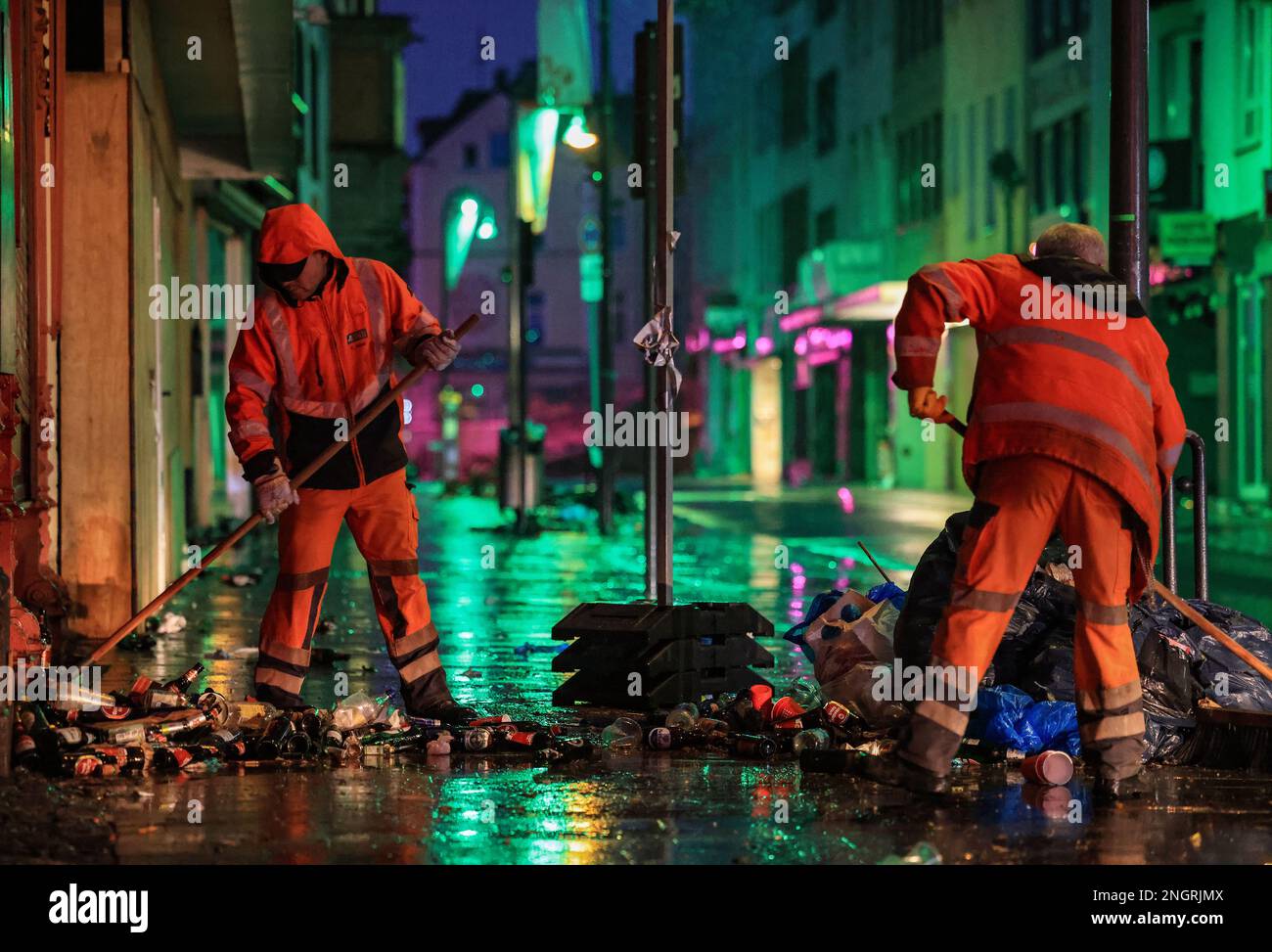 Cologne, Germany. 19th Feb, 2023. Street cleaning employees sweep up ...